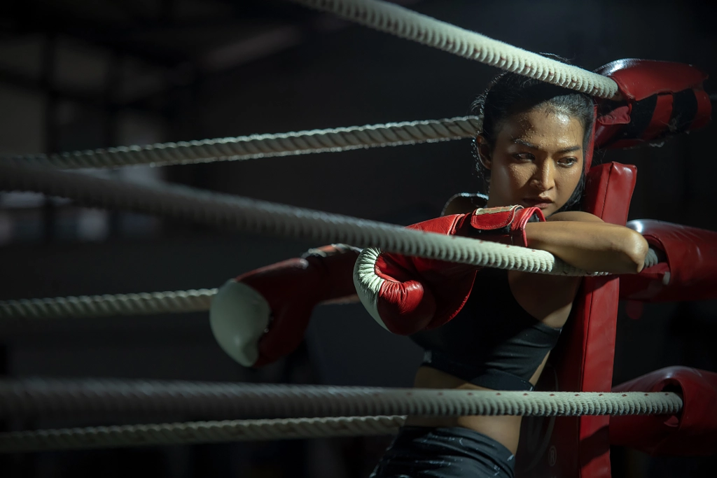 Upset young fighter boxer girl wearing boxing gloves in gym,Fema by ...
