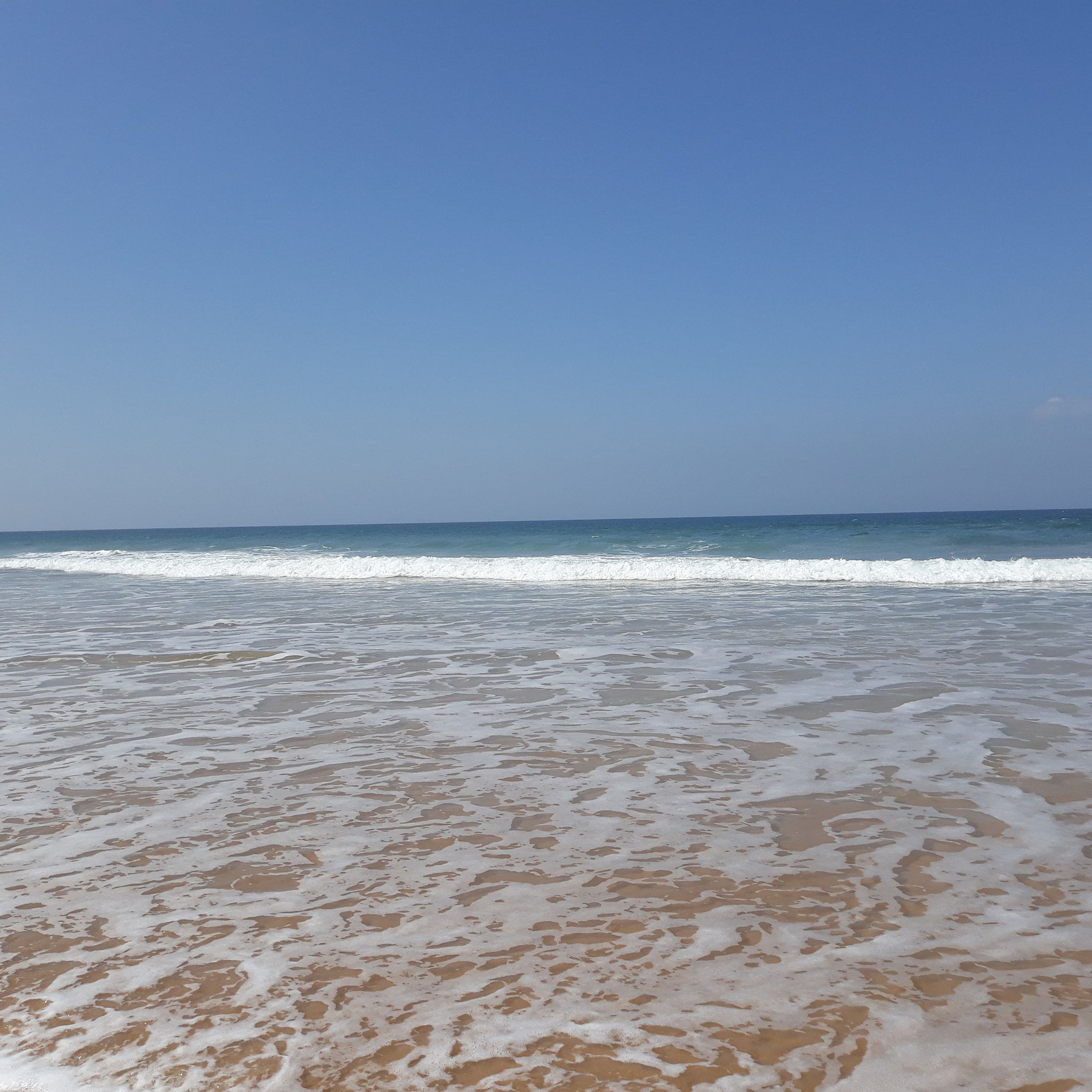 Ocean Waves on a Sandy Beach Under Blue Sky | landscape photo by Lucina ...