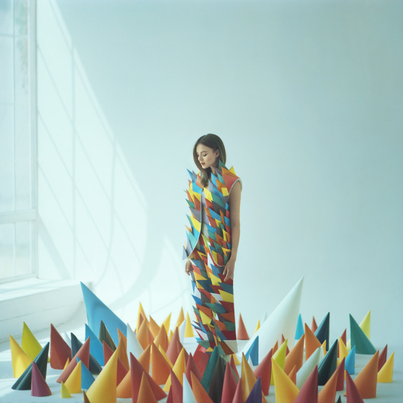 Woman in Colorful Geometric Dress Standing Among Paper Cones | people ...