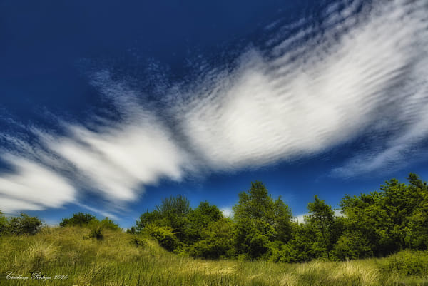 Cloud Streaks Over Green Grassy Hills | landscape photo by Cristian ...