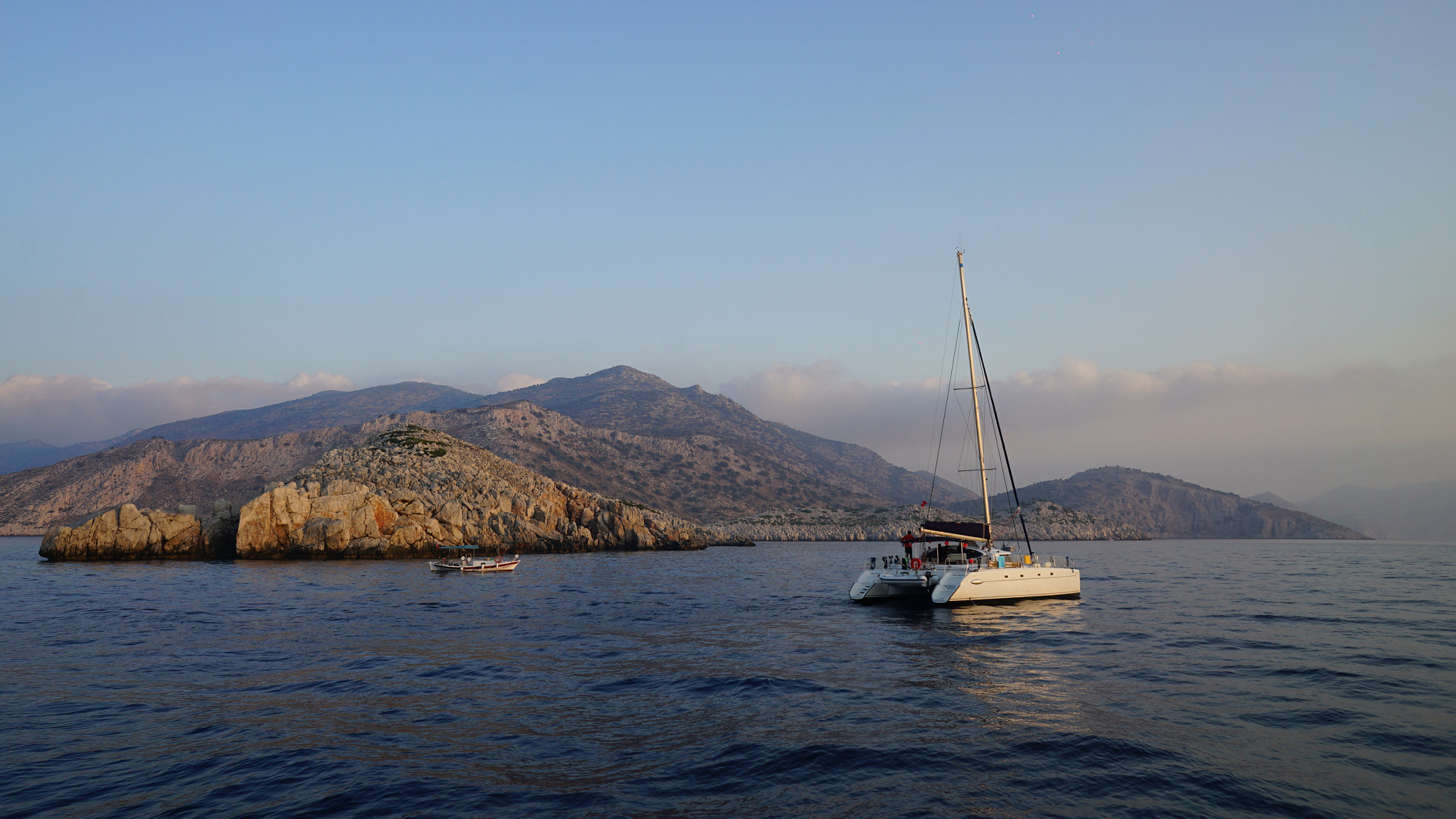 Catamaran Sailing Near Rocky Islands at Sunset | landscape photo by ...