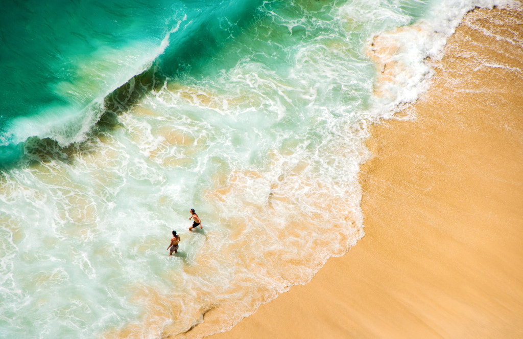 Aerial view of people surfing in sea by Ricky Rueda / 500px