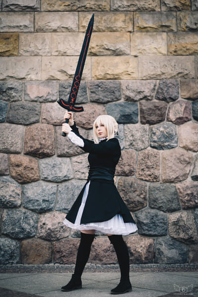 Cosplay Character with Sword Against Stone Wall | events photo by ...