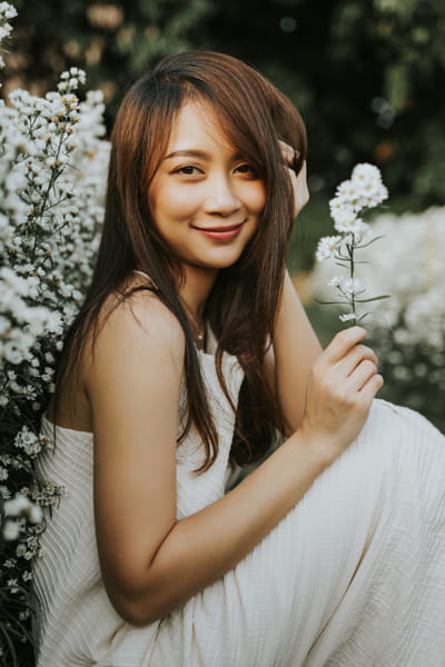 Portrait of thai woman sitting in flower field by Natalie Zotova | 500px