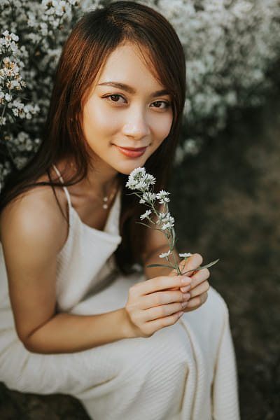 Portrait of thai woman sitting in flower field by Natalie Zotova | 500px