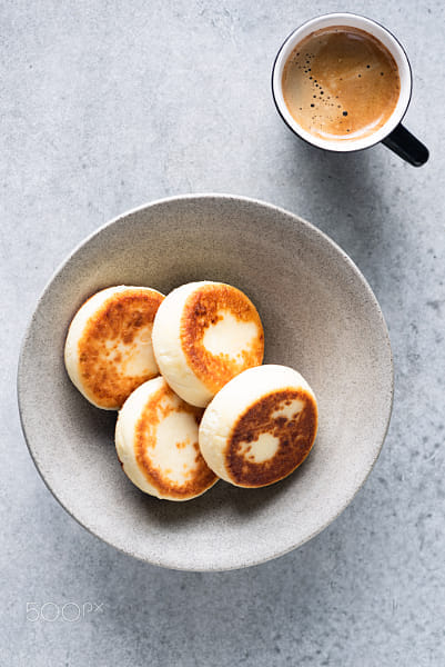 Cottage cheese fritters with cup of espresso coffee by Vladislav Nosick ...