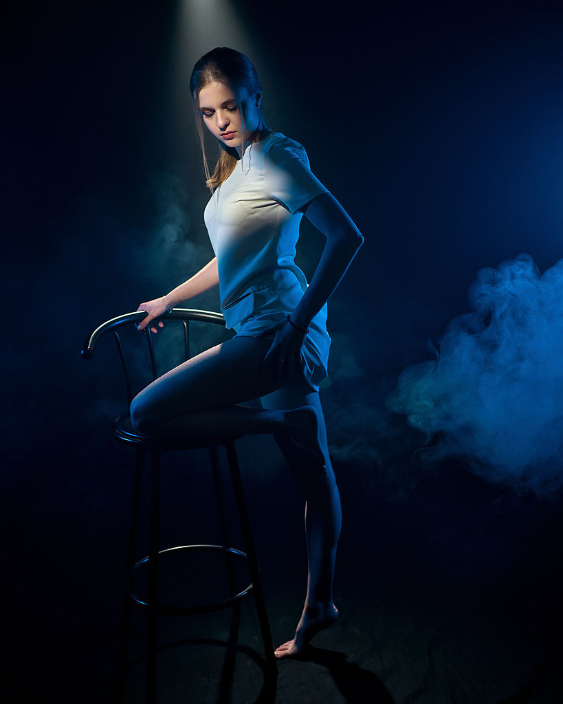 portrait of woman standing against black background by Andy Khan / 500px