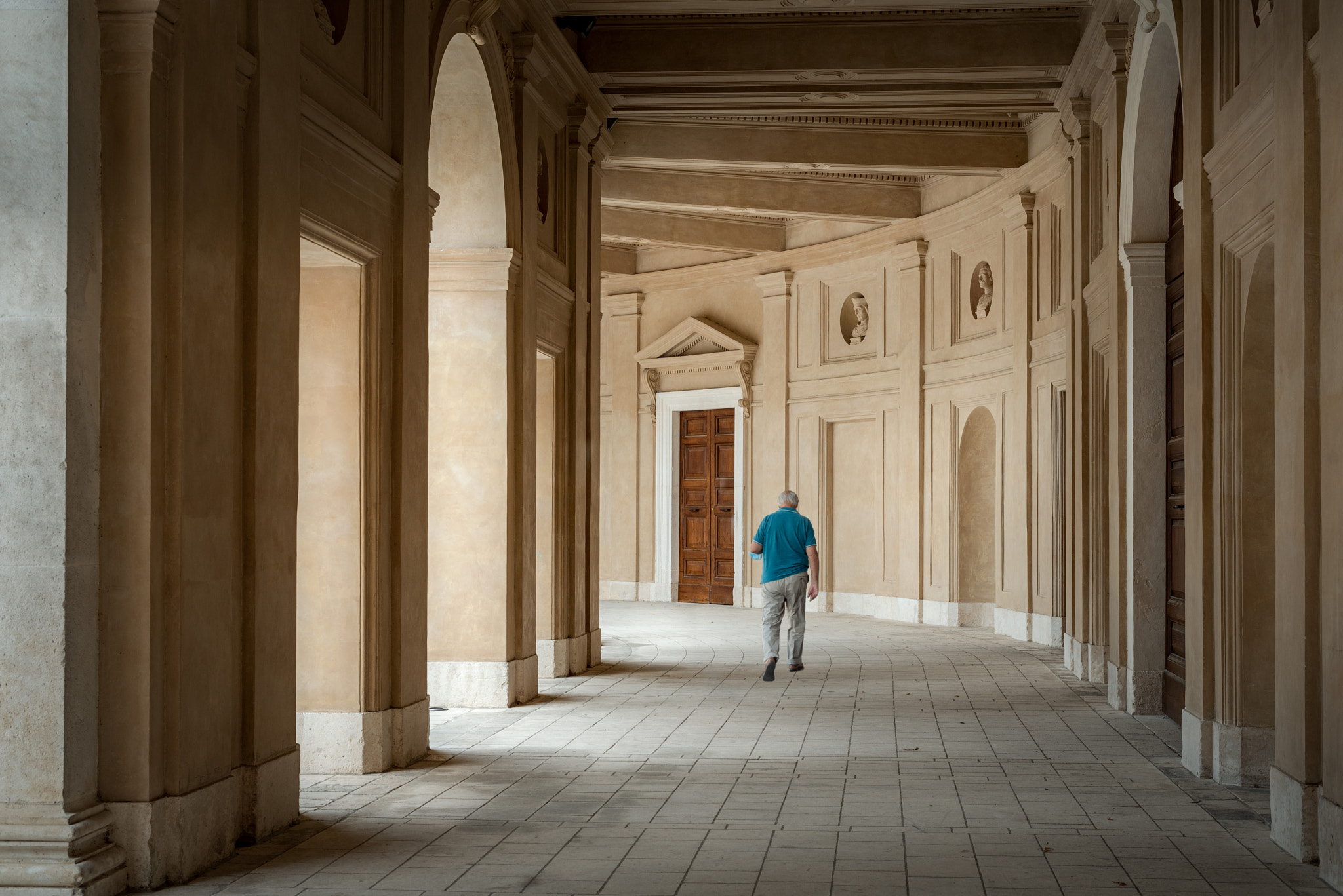 A man is walking along the corridor by Simona Haller / 500px