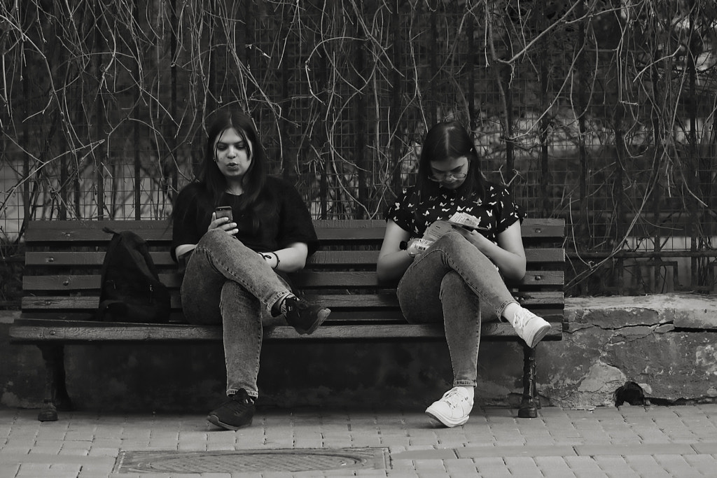Girls are sitting on a bench by Nick Trifonov / 500px