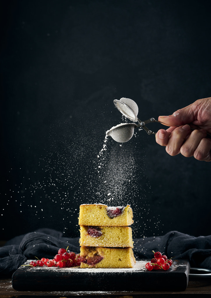 Stack of square slices of baked plum biscuit cake by Natalia Danko / 500px