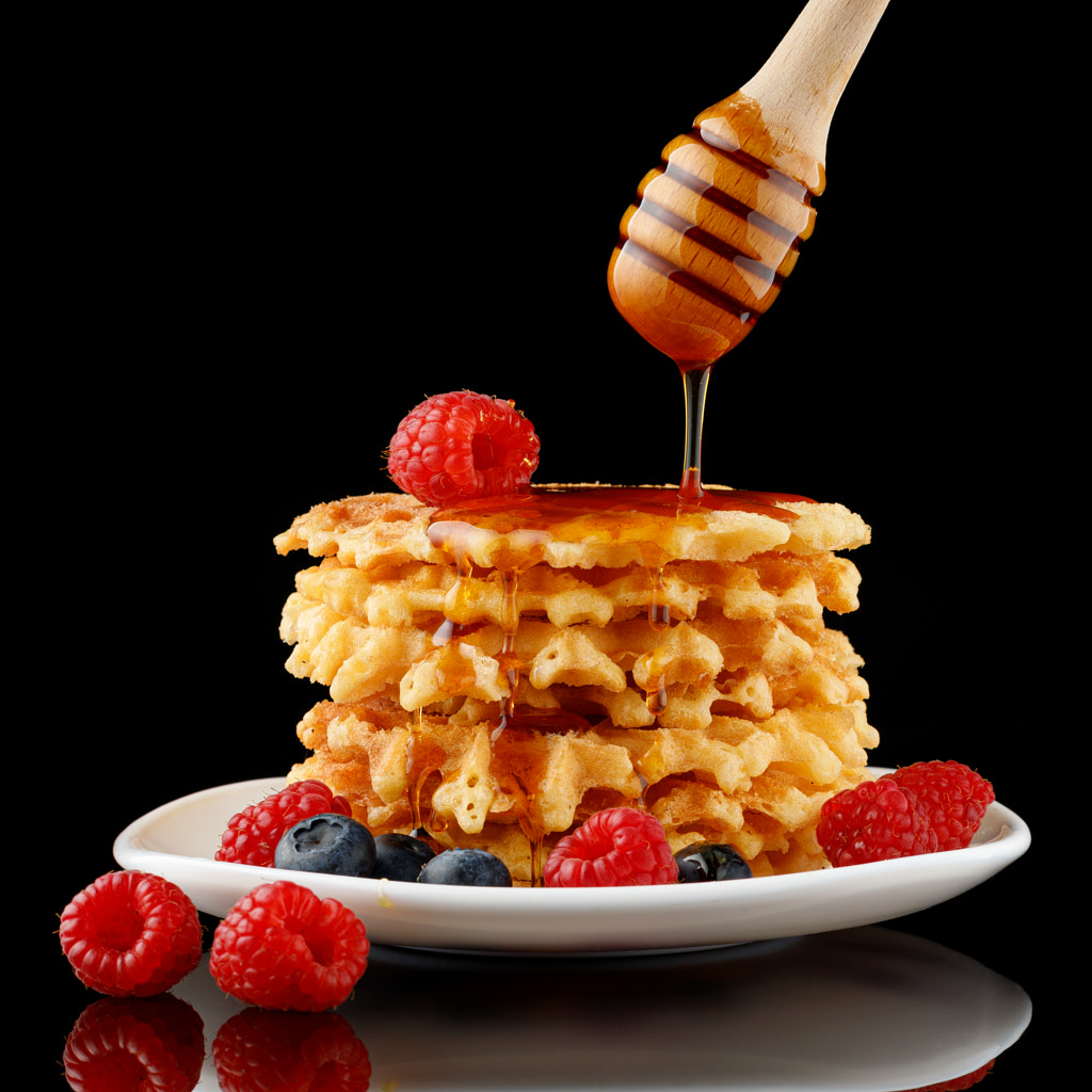 Belgian waffles with honey and berries by Pavlo / 500px