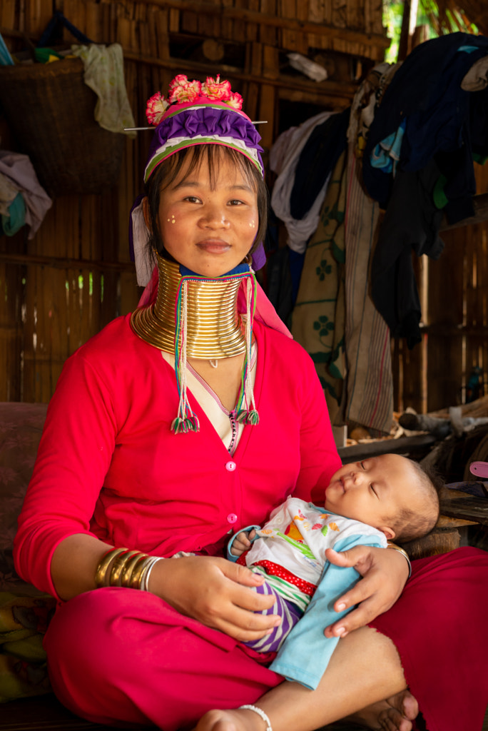 Long Neck tribe mother holding child. by Enrique Moreno / 500px