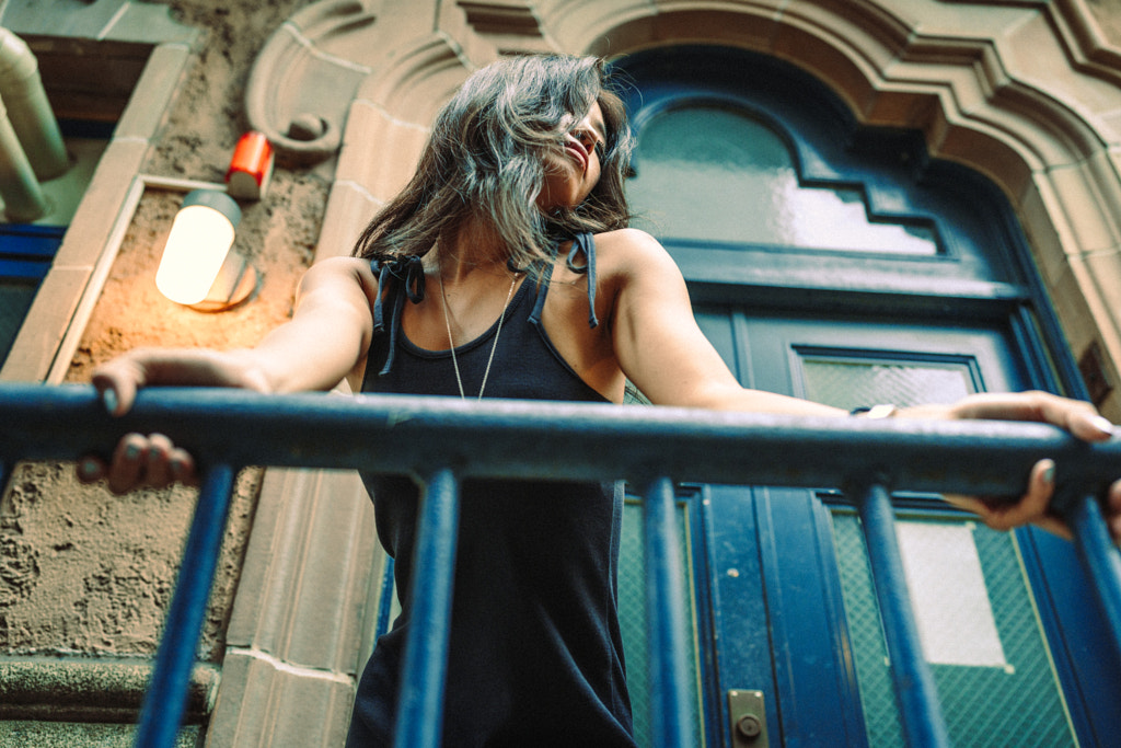 Woman standing against building by Kaoru Nakamura / 500px