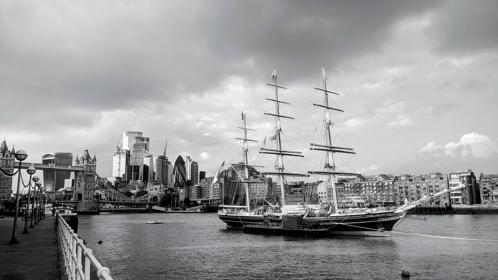 Old ship docked by Tower Bridge in London by Sergei Golubev / 500px