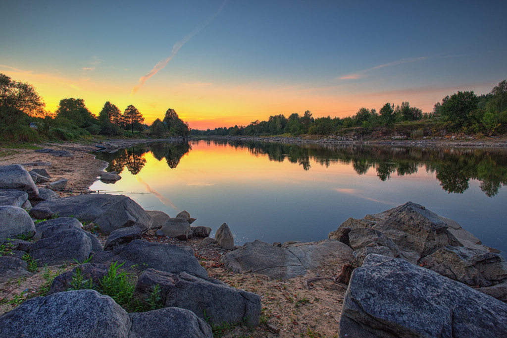 Scenic view of lake against sky during sunset by Alexander Sinitsky / 500px
