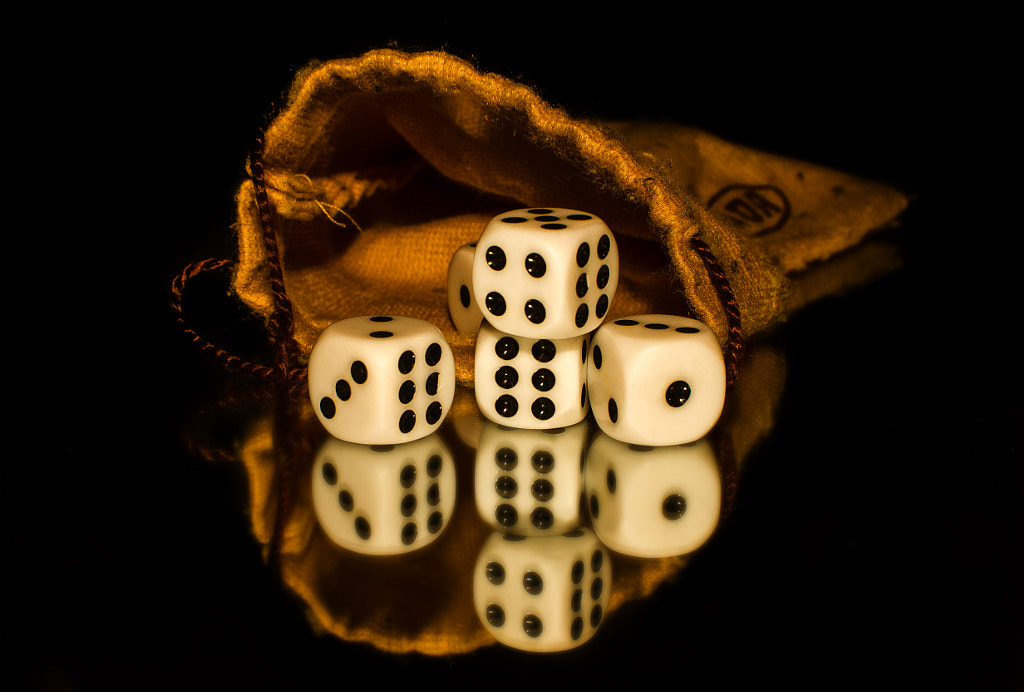 Close-up of dices with dice on black background by David Labat / 500px