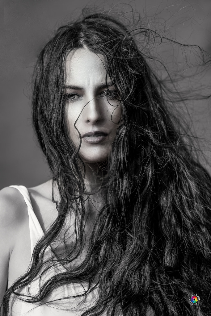 Portrait of young woman with long hair by Manbos Garcia / 500px