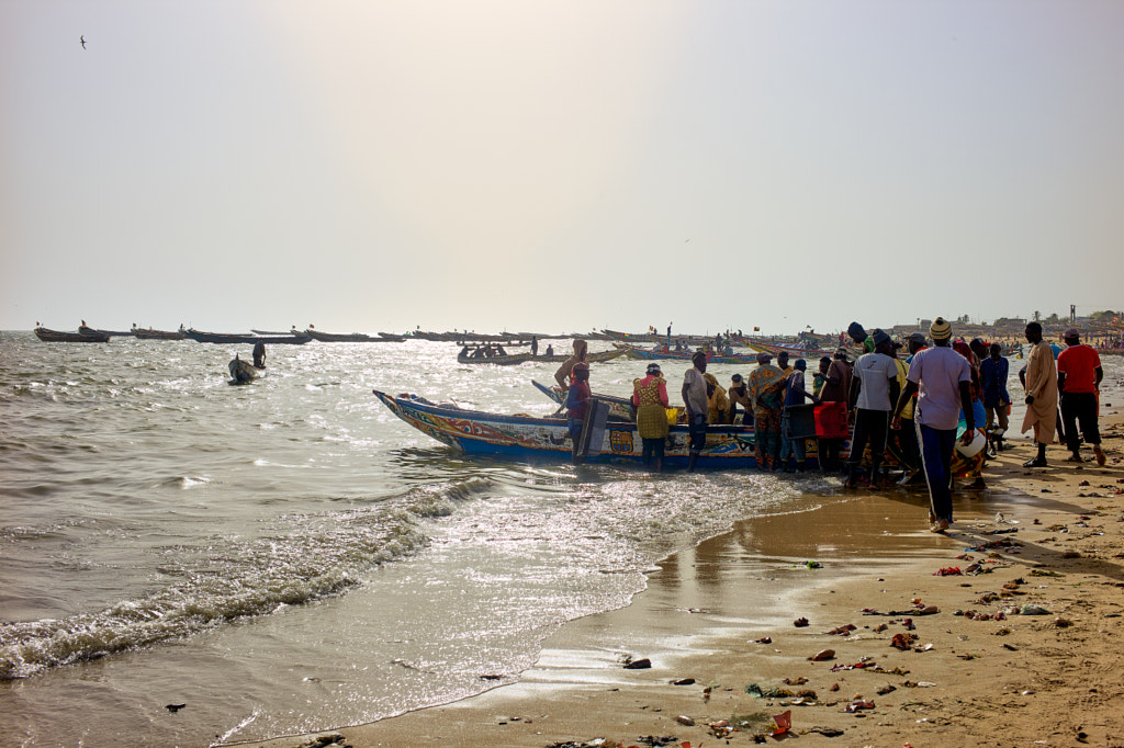 People at beach against clear sky by Jacint Guiteras / 500px