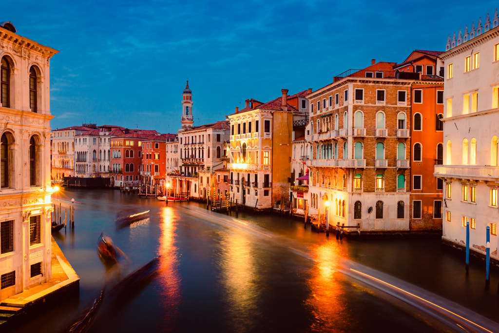 Venice's Grand Canal at sunset with illuminated historic buildings and ...