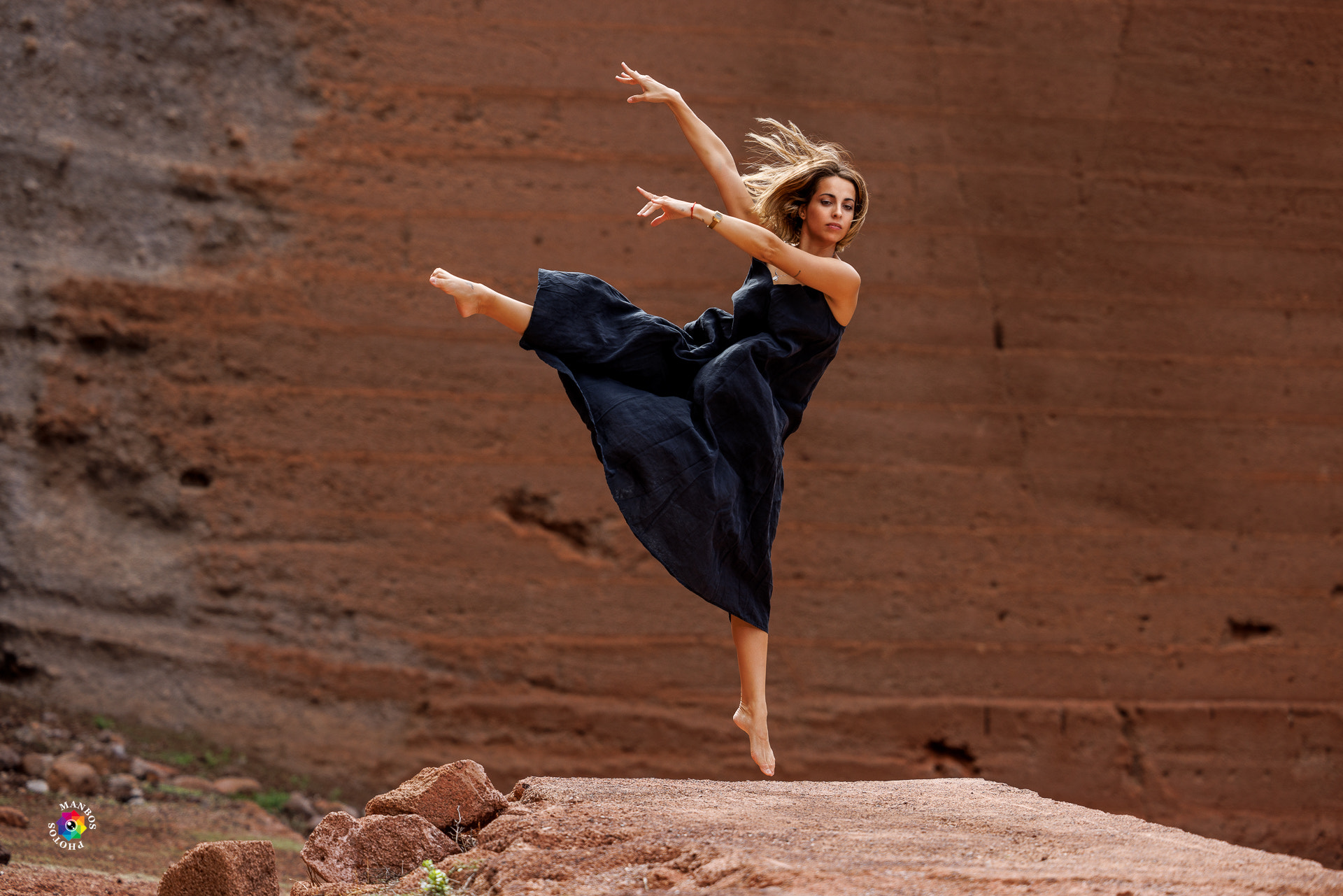 Full length of woman dancing on rock against wall by Manbos Garcia / 500px