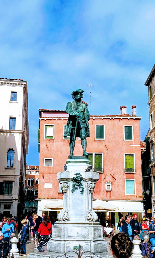 People walking around Marco Polo Statue in Venezia Italy by Armando ...