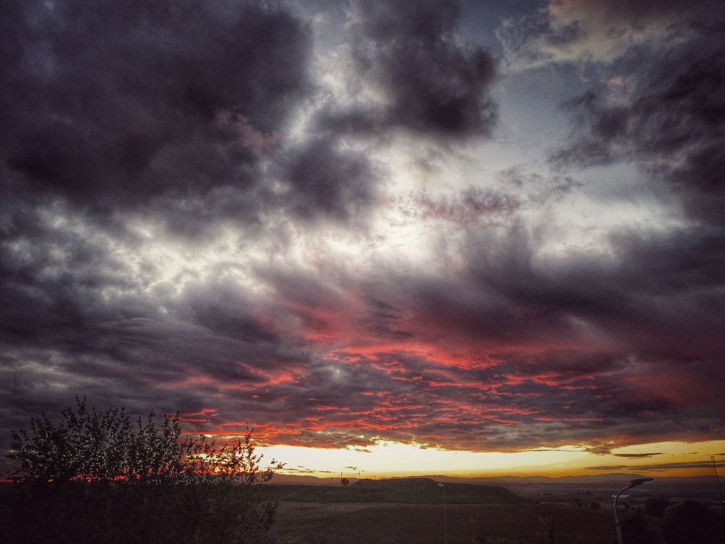 Scenic view of dramatic sky over land during sunset by Pasqualina ...