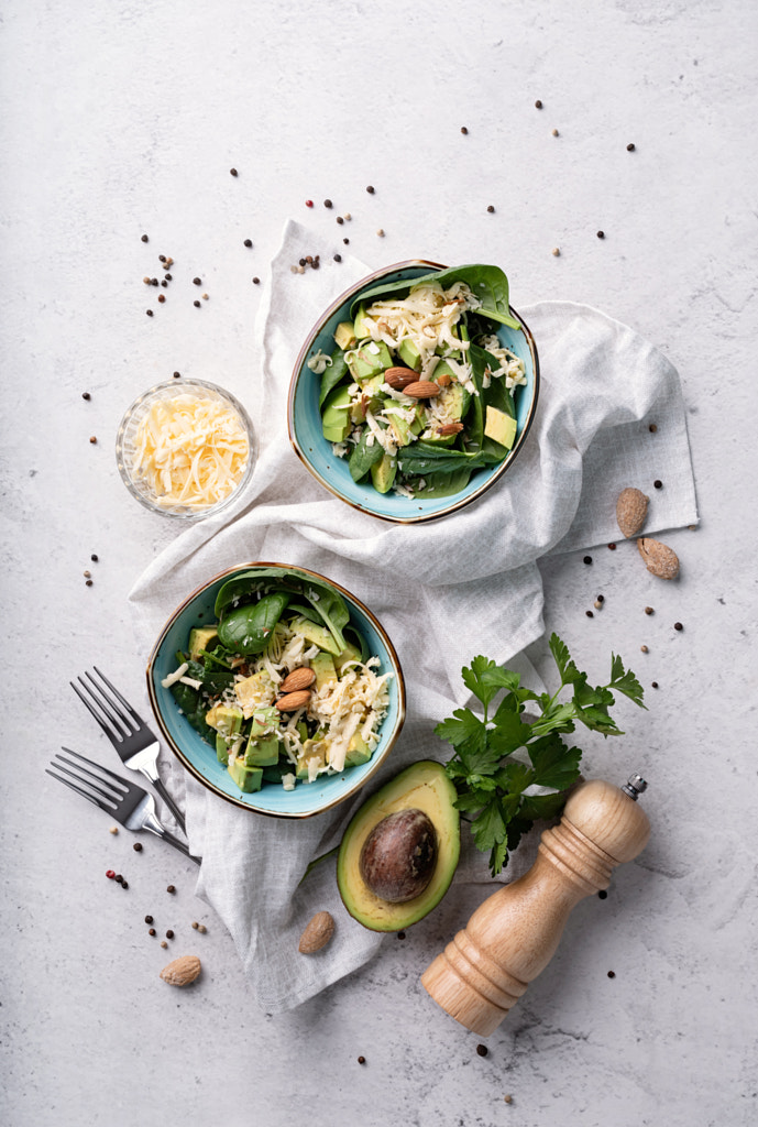Top view of fresh summer avocado and spinach salad bowls by ilona ...