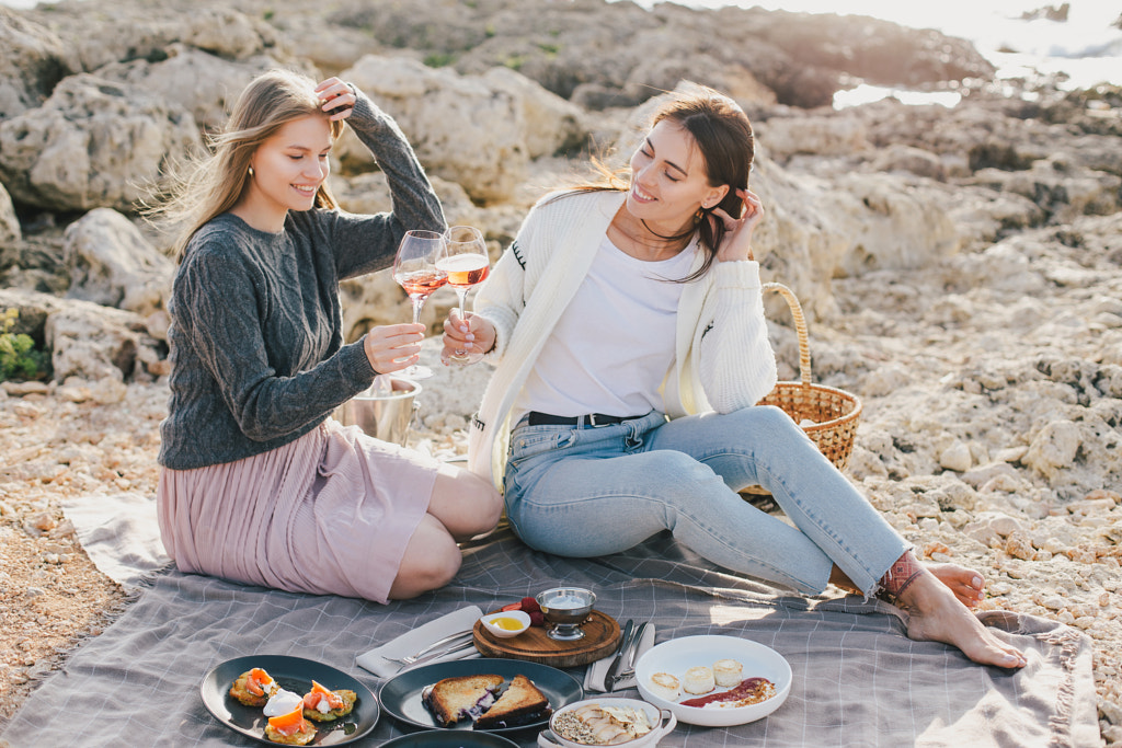 Two women female friends having picnic brunch with fresh homemade food ...