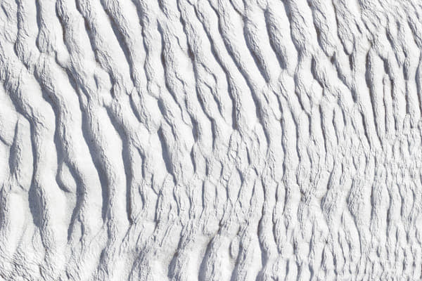 Ribbed abstract vertical texture of Pamukkale calcium travertine in ...