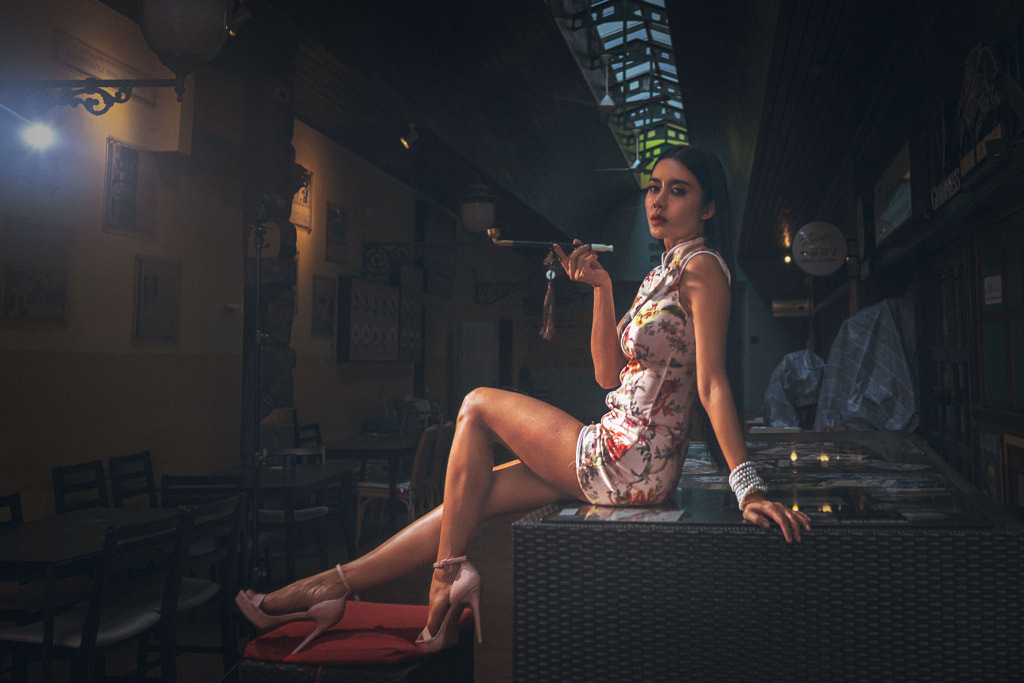 Day Jitprasong~Portrait of woman sitting on seat at night by Steven Chiow / 500px