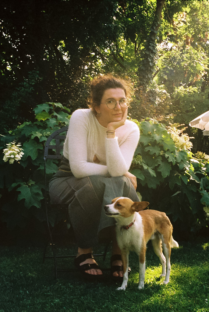 Woman with dog in garden (analog shot) by Carlotta Ricci / 500px
