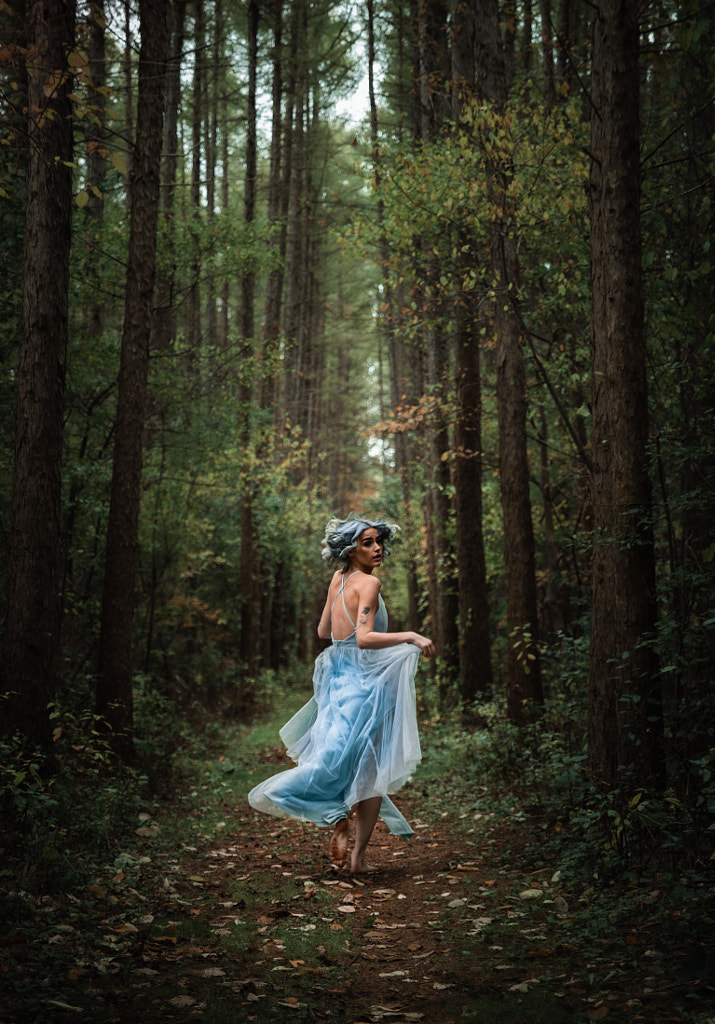 Young Girl in Blue Dress Running Through the Forest by Seth Macey / 500px