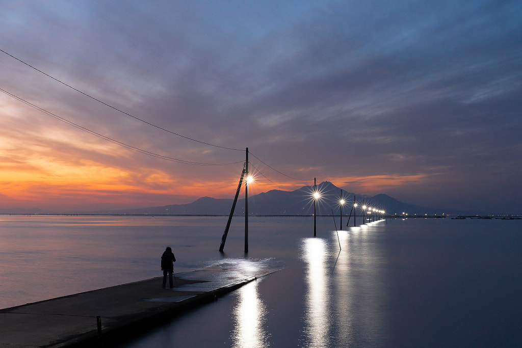 Silhouette man fishing in sea against sky during sunset by Masanobu ...