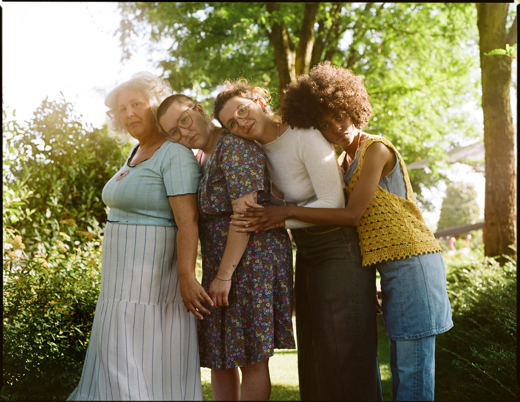 Family standing in garden (analog shot) by Carlotta Ricci / 500px