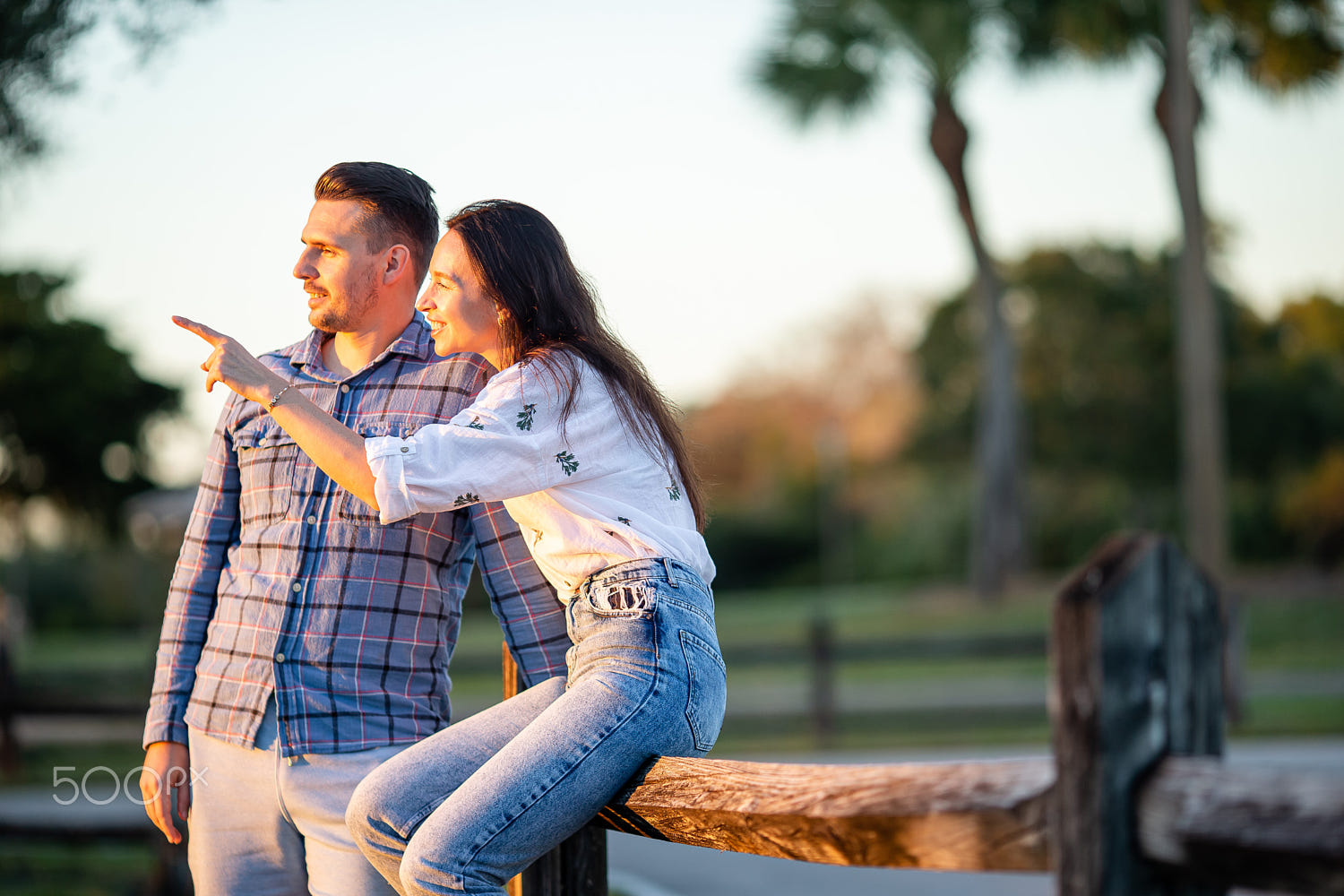 Happy couple in the park on summer day outdoors by Dmitrii Travnikov ...