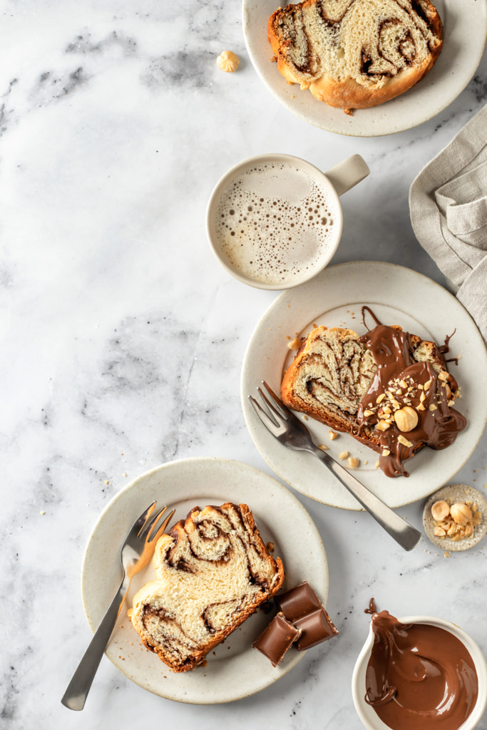 Three plates of sliced brioche babka bread with chocolate filling on by ...
