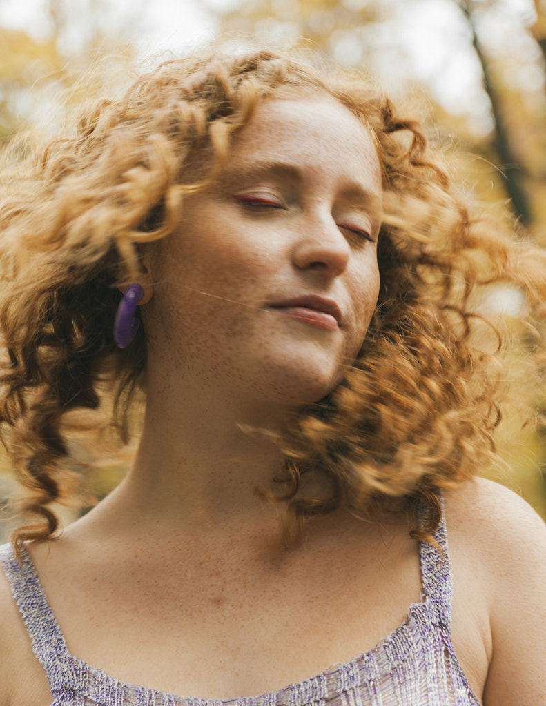 Close-up of young woman with curly hair by Carlotta Ricci / 500px