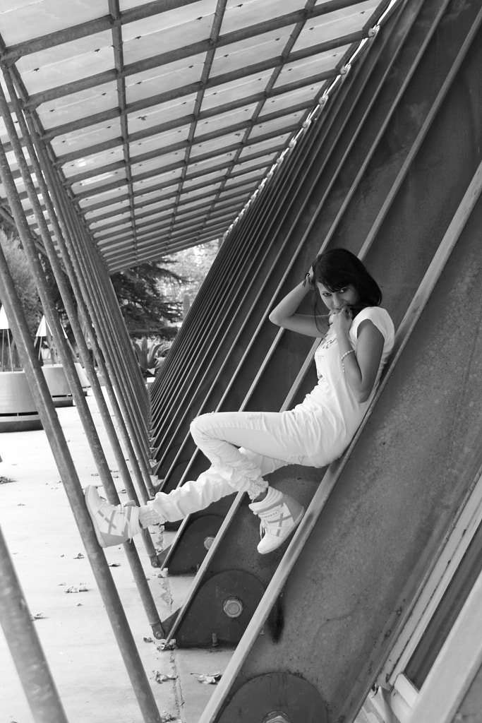 Low angle view of woman sitting on railing by Bruno Vilbé / 500px