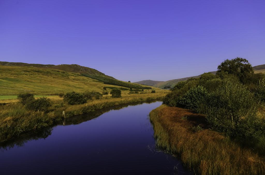 Scenic view of lake against clear blue sky by Hilda Murray / 500px