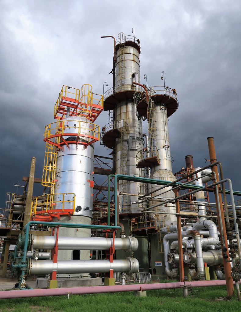 Dark clouds over refinery by Alfredo H. Conconi / 500px
