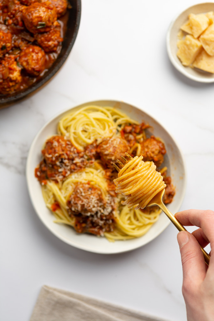 Spaghetti wrapped on fork. Italian pasta with meatballs, tomato sause ...