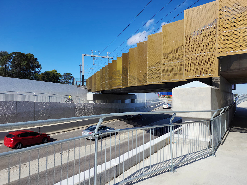 Bronze bridge with vehicle and cyclist during the morning by Matt Leane ...