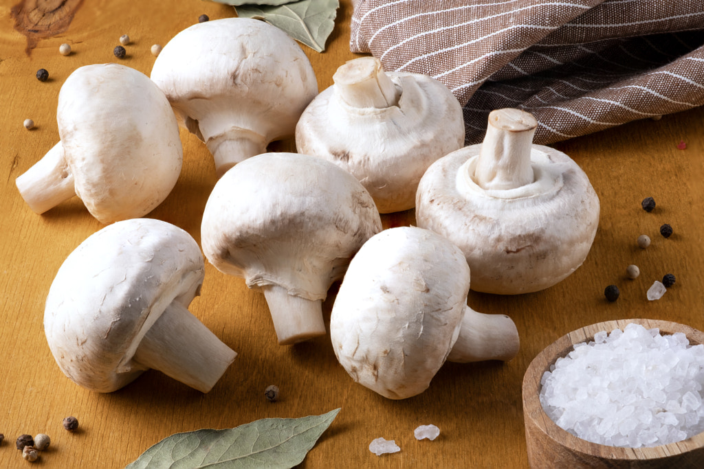 Close-up of champignon mushrooms and spices by Olga Gubskaya / 500px