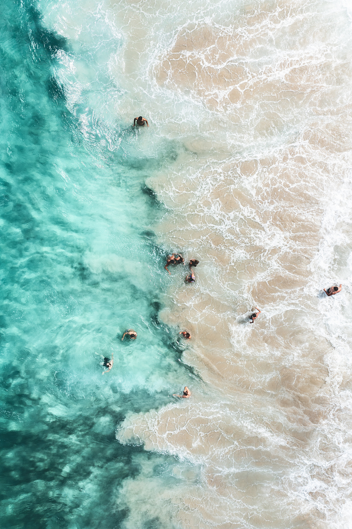 Aerial view of people surfing in sea by Ricky Rueda / 500px