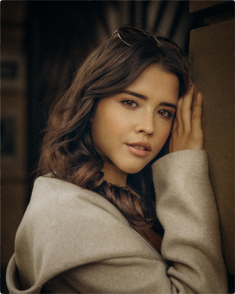 Young Woman with Brown Hair Leaning Against Wall | people photo by ...