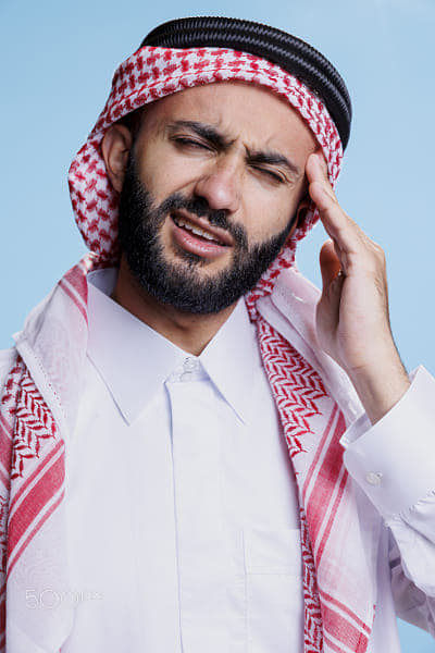 Muslim man showing sign of migraine by Dragos Condrea | 500px