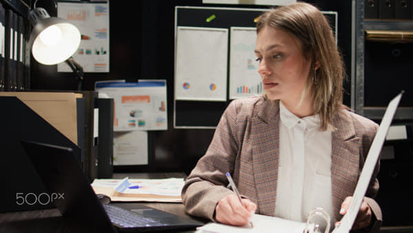 Detective examines evidence on laptop by Dragos Condrea | 500px