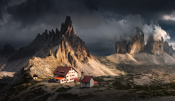 Dramatic Mountain Landscape with Small House Under Stormy Sky ...