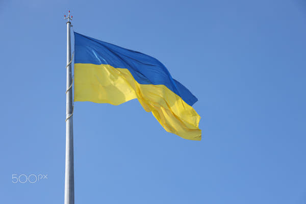 Ukrainian flag isolated on the blue sky with clipping path. Close up ...