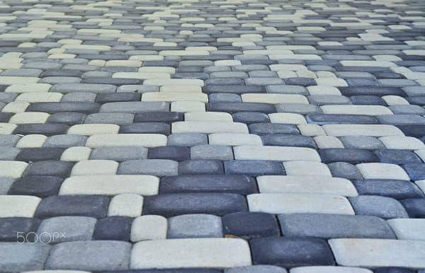A detailed photo of the square, laid out of modern paving stone with ...